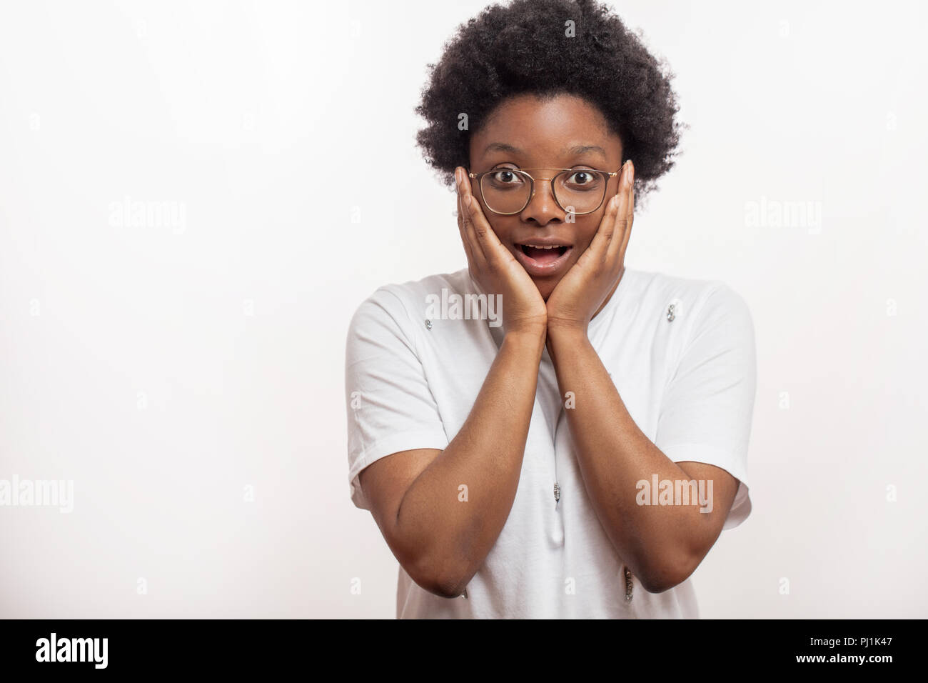 surprised awesome woman holding cheeks by hand Stock Photo - Alamy