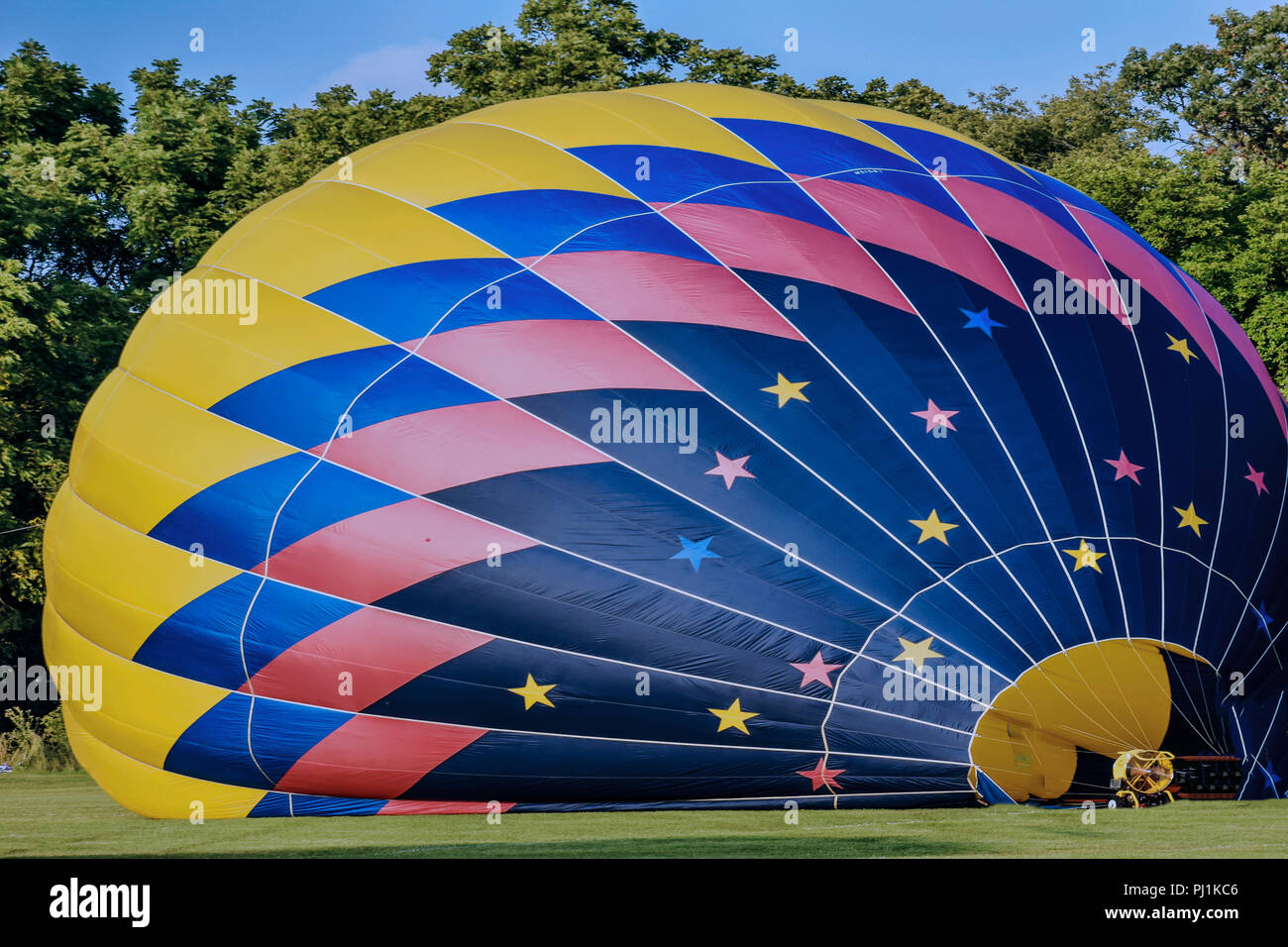 Colorful hot air balloon rising in air Stock Photo - Alamy