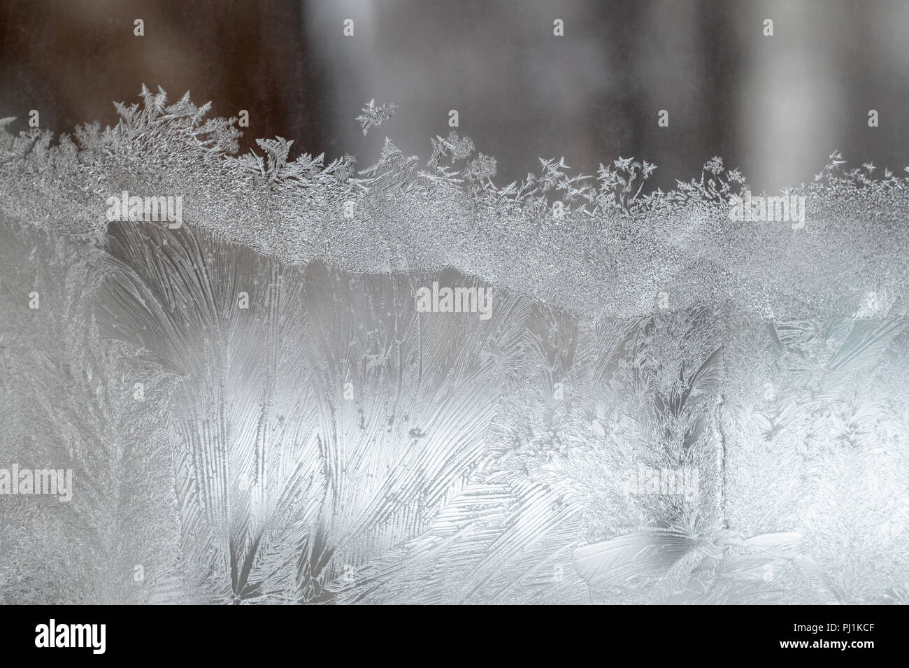 Frozen ice patterns on glass Stock Photo - Alamy