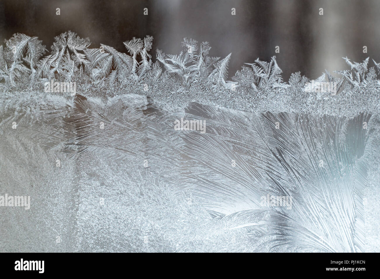 Frozen ice patterns on glass Stock Photo - Alamy