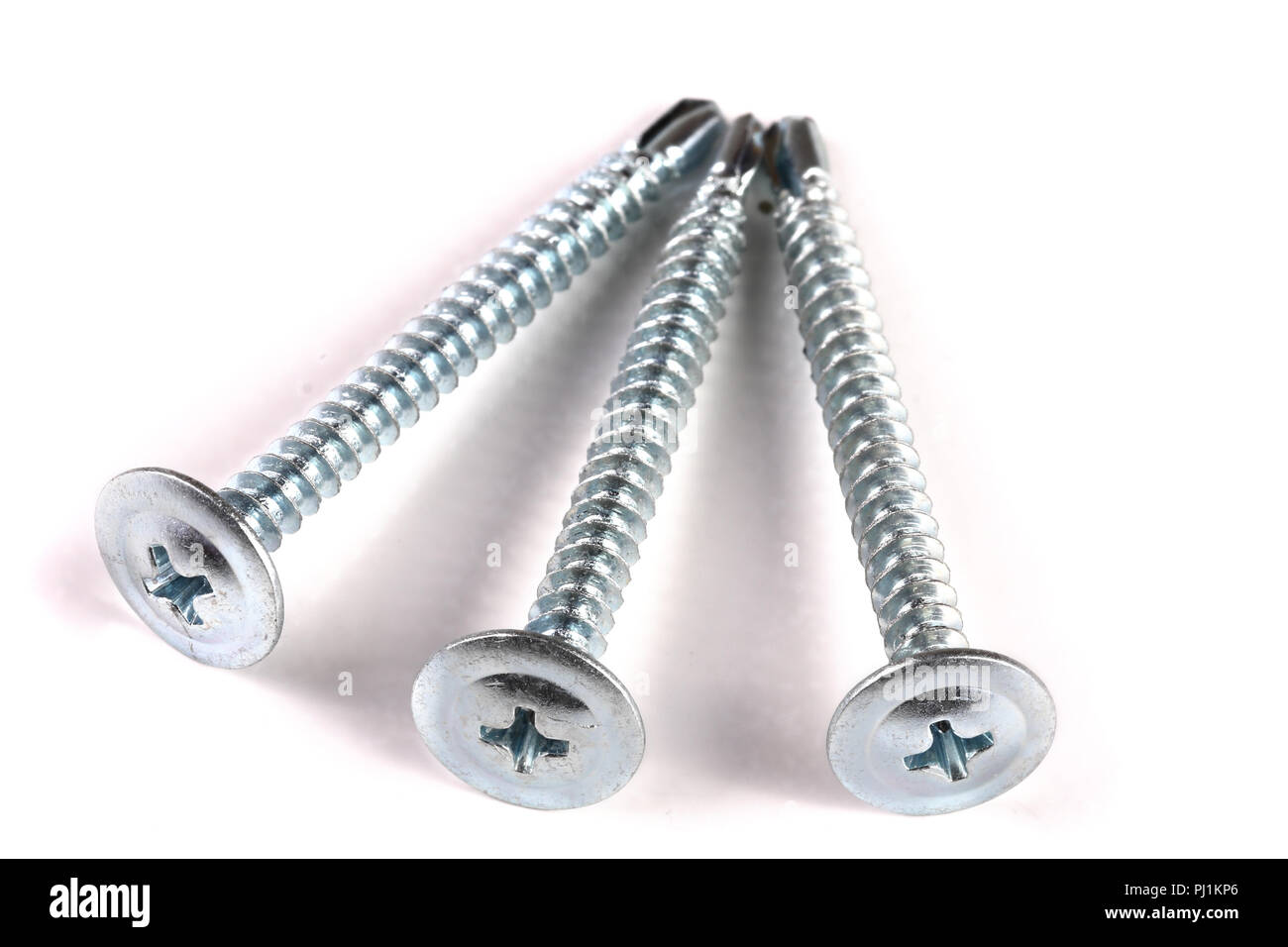 three metal screws isolated on white background closeup Stock Photo - Alamy