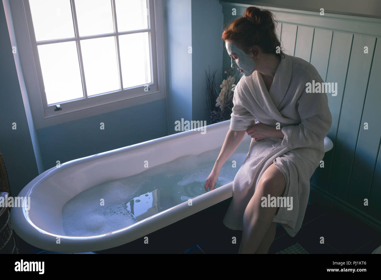 Sitting on bathtub hi-res stock photography and images - Alamy