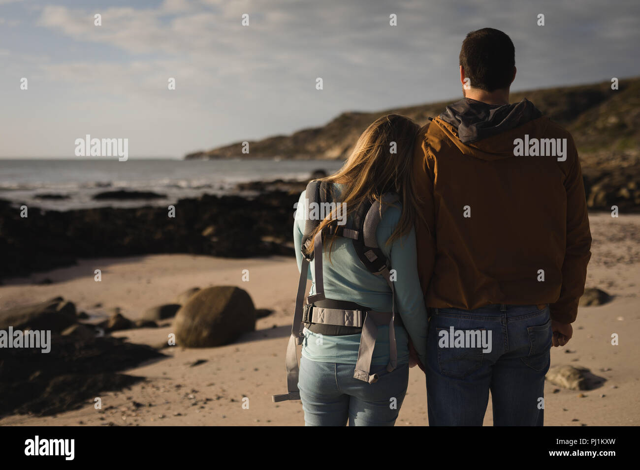 Couple walking on beach Stock Photo - Alamy