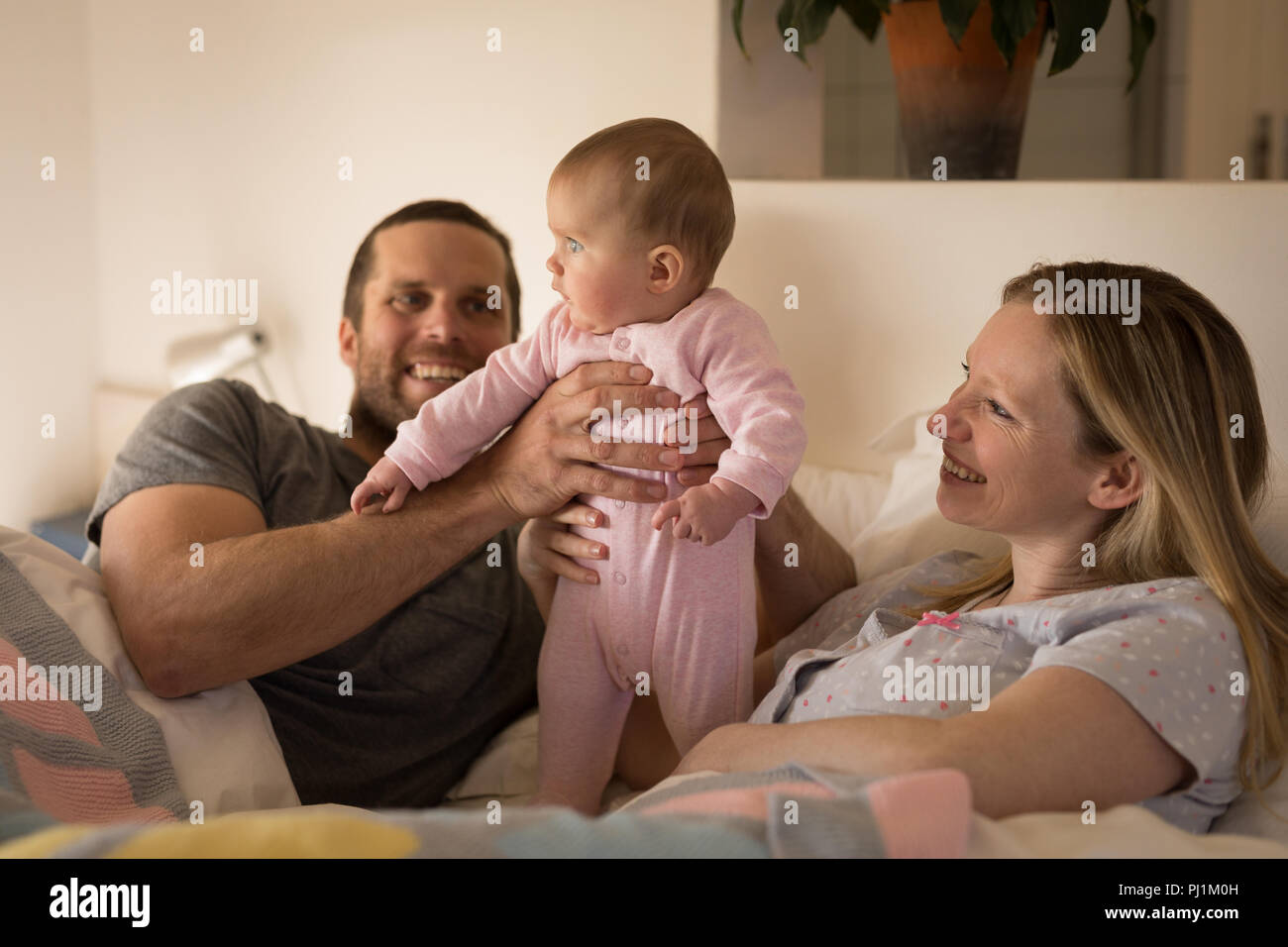 Parents lying on bed hi-res stock photography and images - Alamy