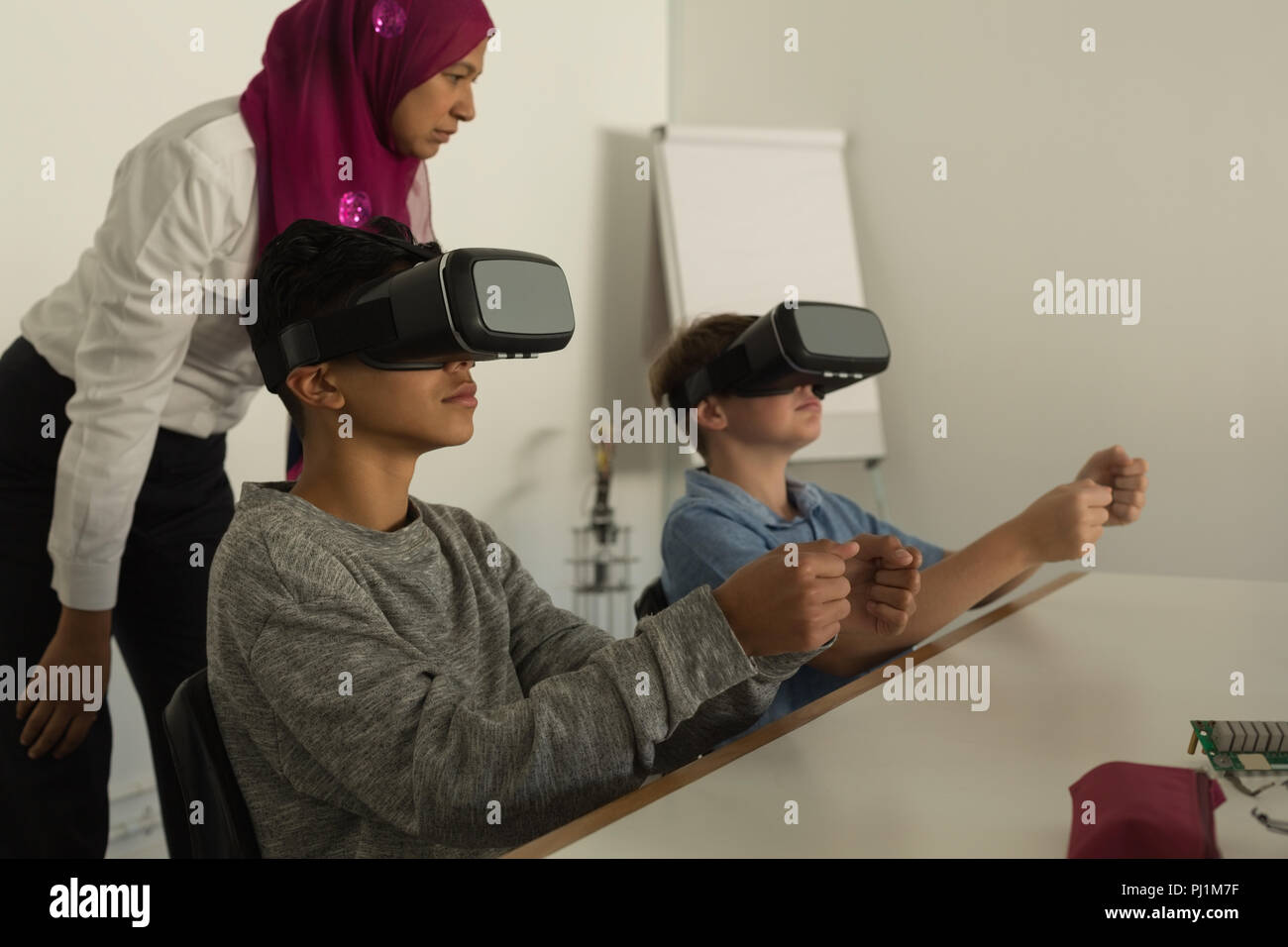 Female pilot giving training on virtual reality headset to students ...