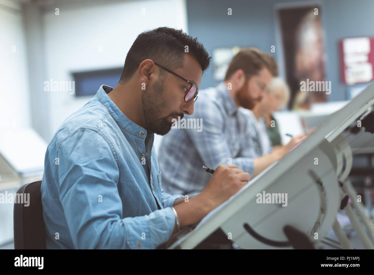 Executive working on drafting table Stock Photo - Alamy