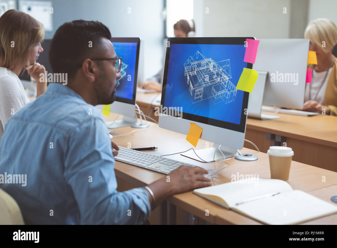 Executive working on desktop pc at desk in office Stock Photo - Alamy
