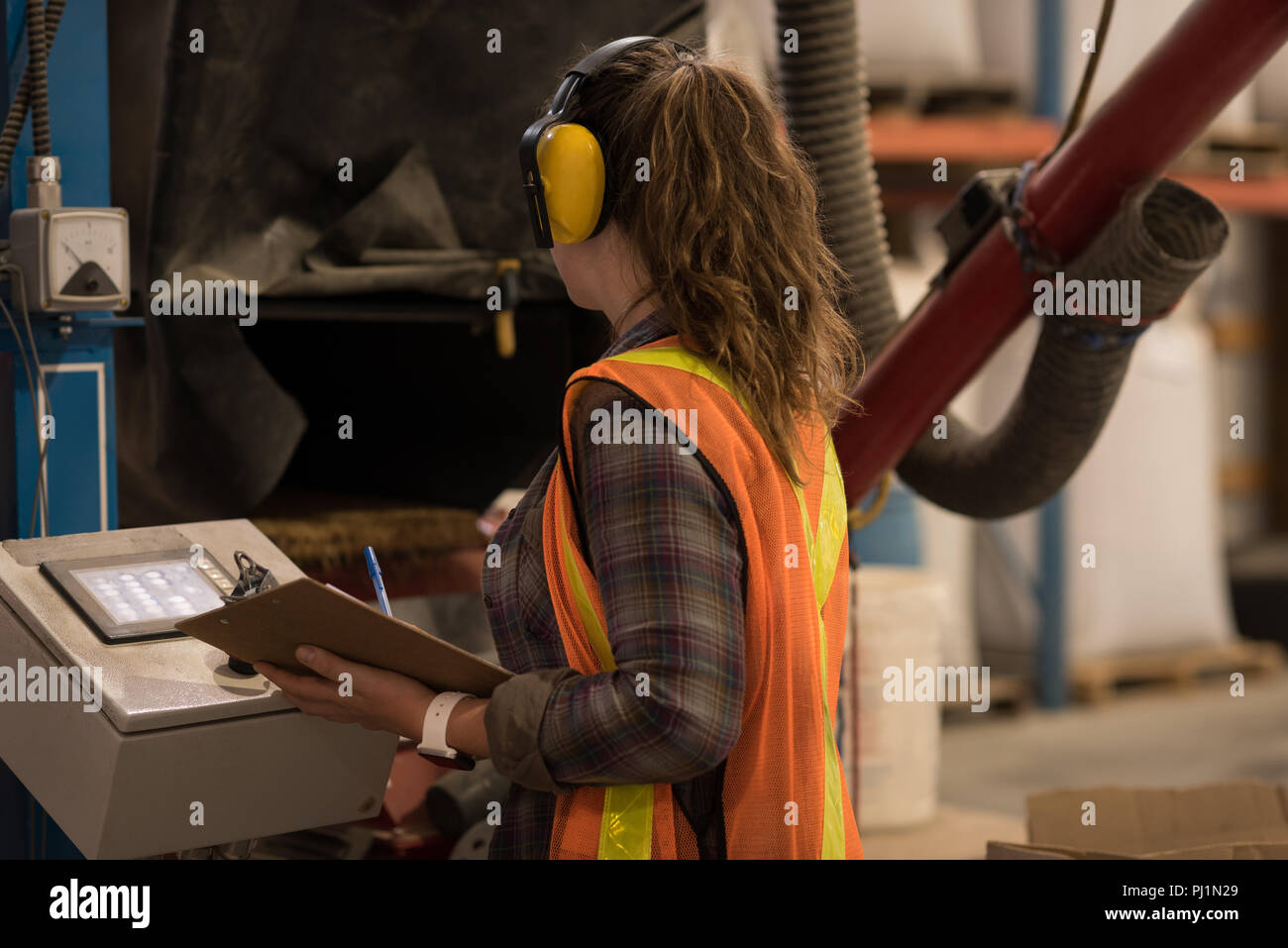 Female worker operating machine Stock Photo - Alamy