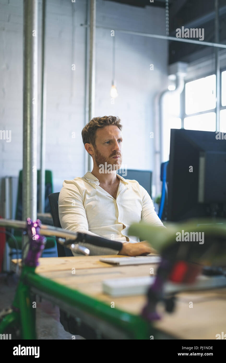 Male executive working on computer at desk Stock Photo - Alamy