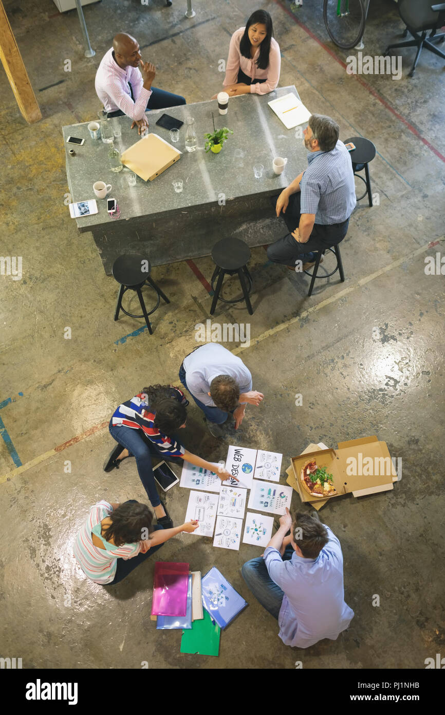 Business people discussing over documents Stock Photo - Alamy