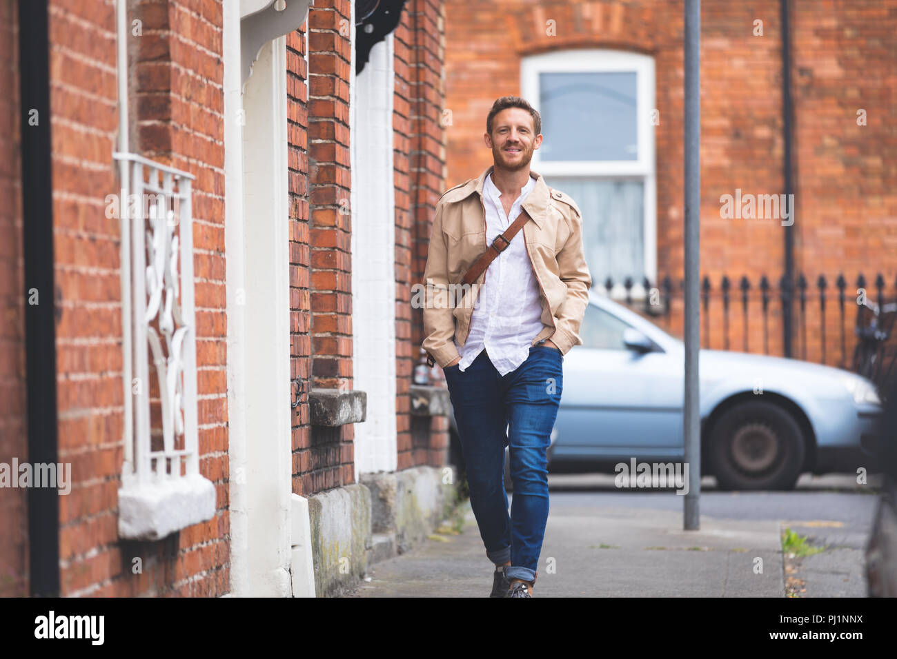 Happy smart casual man walking hi-res stock photography and images - Alamy