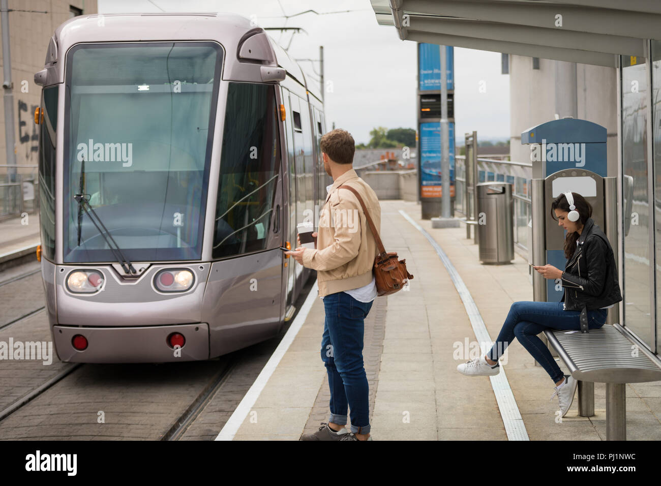 Commuters waiting for train Stock Photo - Alamy