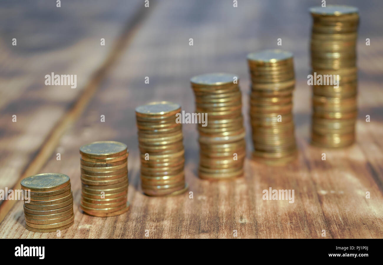 Golden coins showing the scale of growing economic capital Stock Photo ...
