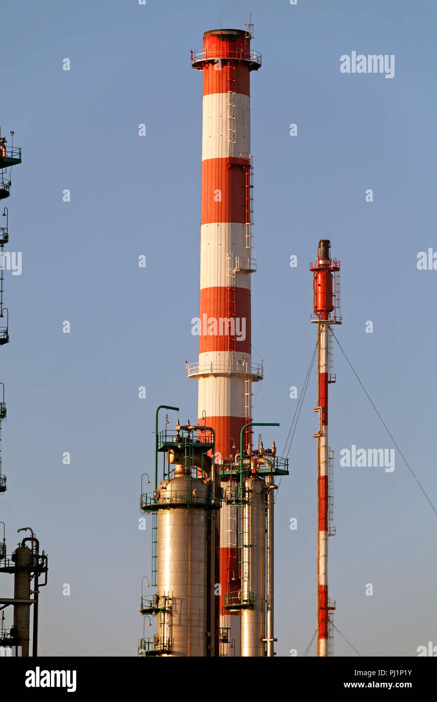 Details of a big oil refinery and powerplant seeing aluminum towers and ...