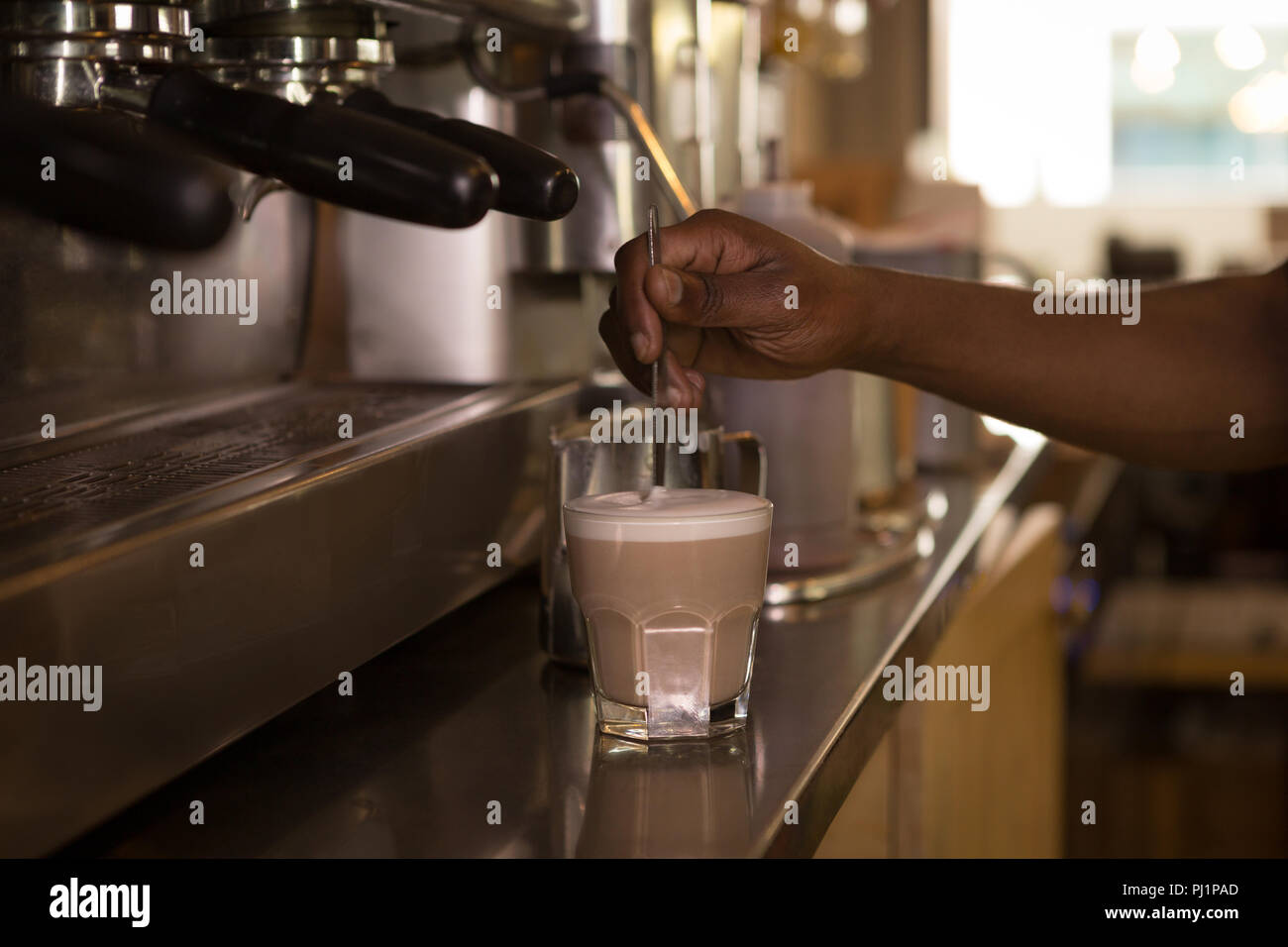 Waiter preparing coffee at counter Stock Photo - Alamy