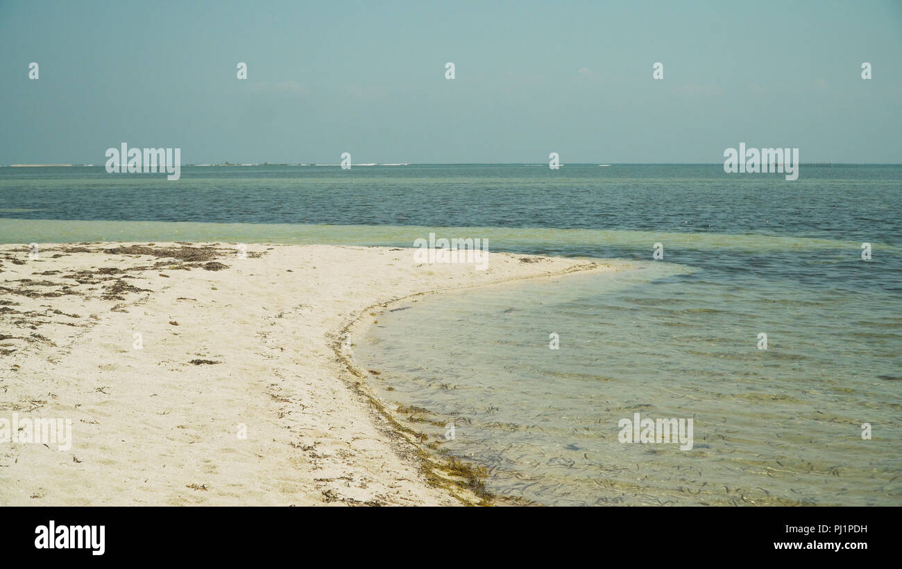 Tropical island with white sandy beach in blue lagoon. Tondol white ...