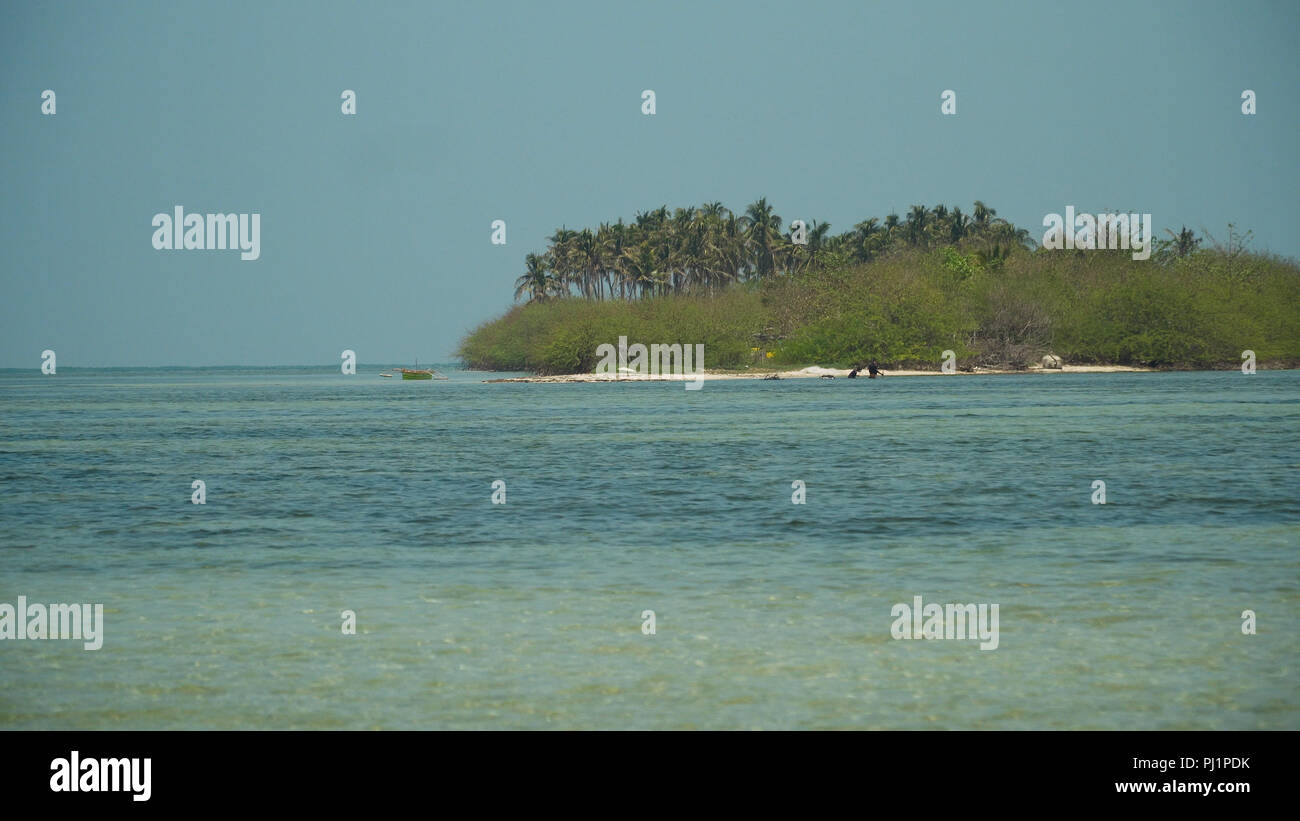 Tropical island with white sandy beach, palm trees in blue lagoon ...