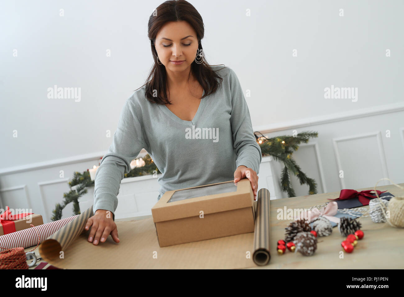 Christmas presents. Gift wrapping process Stock Photo - Alamy