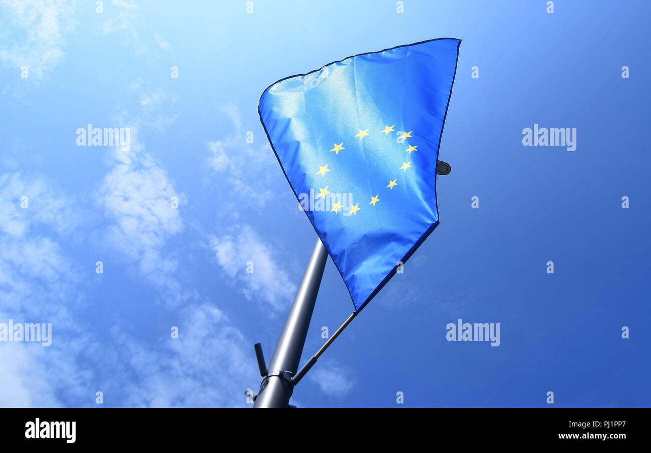 European union flag on blue sky and sun background Stock Photo - Alamy