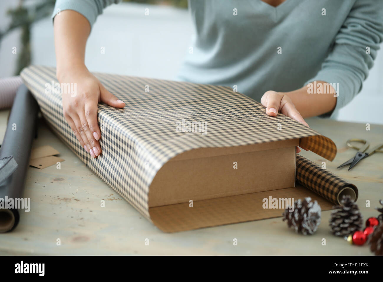 Christmas presents. Gift wrapping process Stock Photo - Alamy