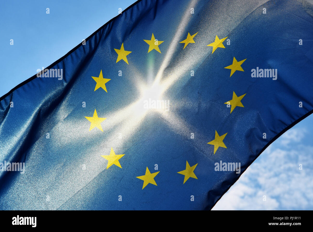 European union flag on blue sky and sun background Stock Photo - Alamy