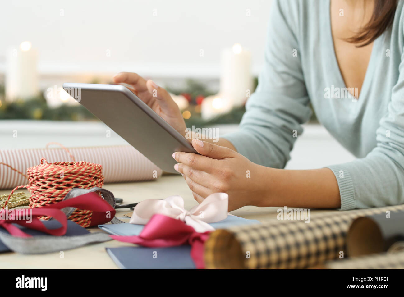 Christmas presents. Gift wrapping process Stock Photo - Alamy
