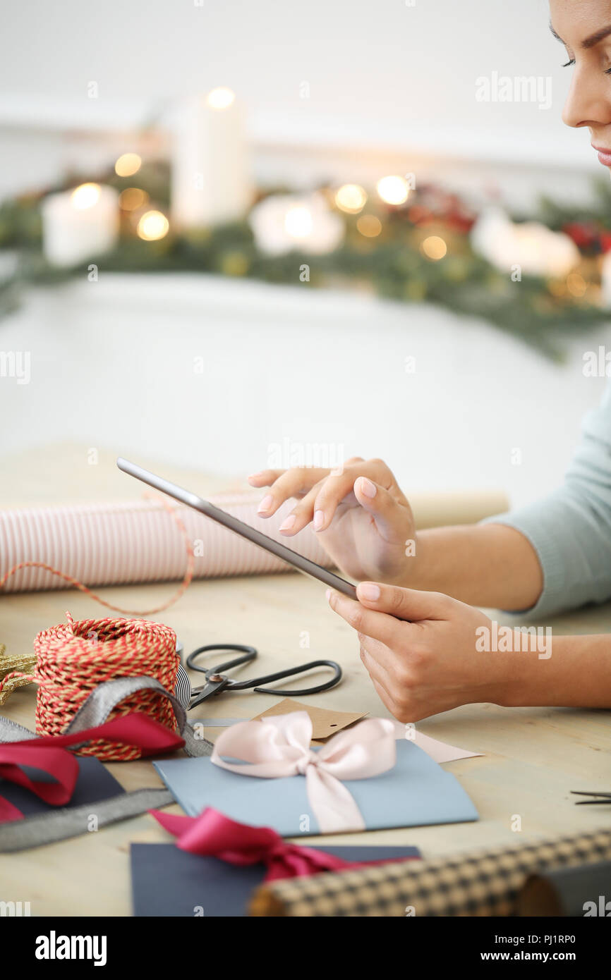 Christmas presents. Gift wrapping process Stock Photo - Alamy