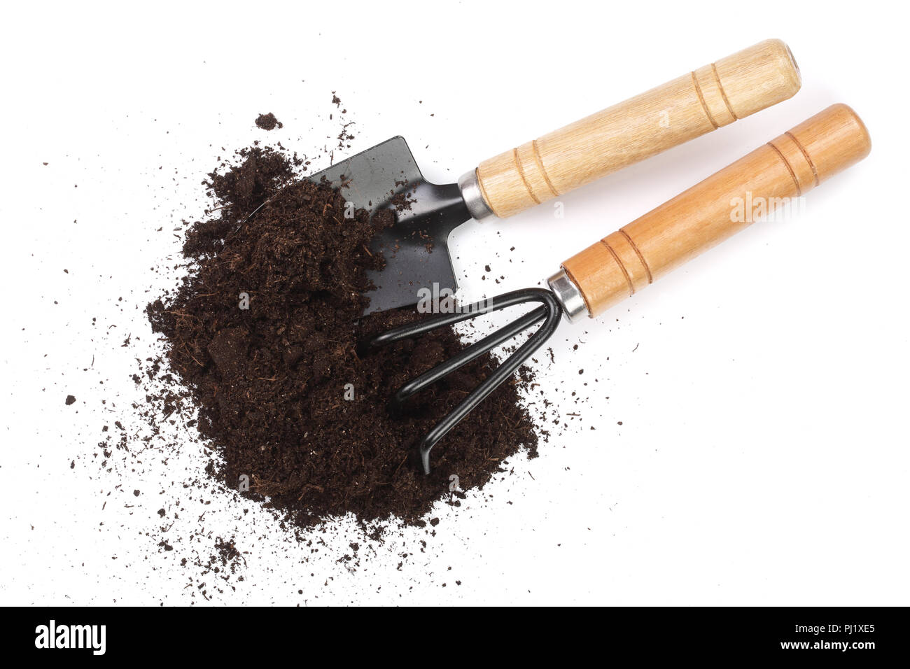 garden tools in soil isolated on white background Stock Photo - Alamy