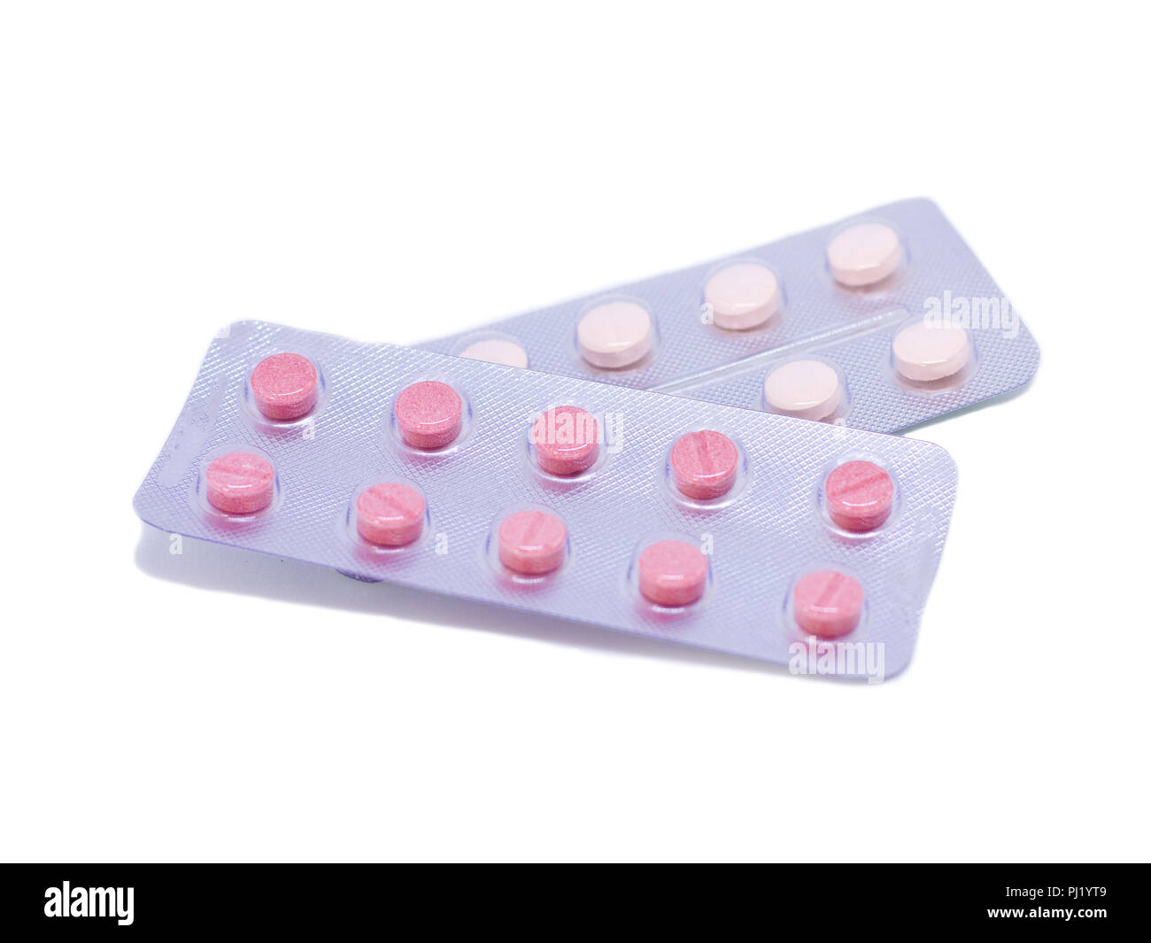 Pink pills in a package isolated on a white background Stock Photo - Alamy