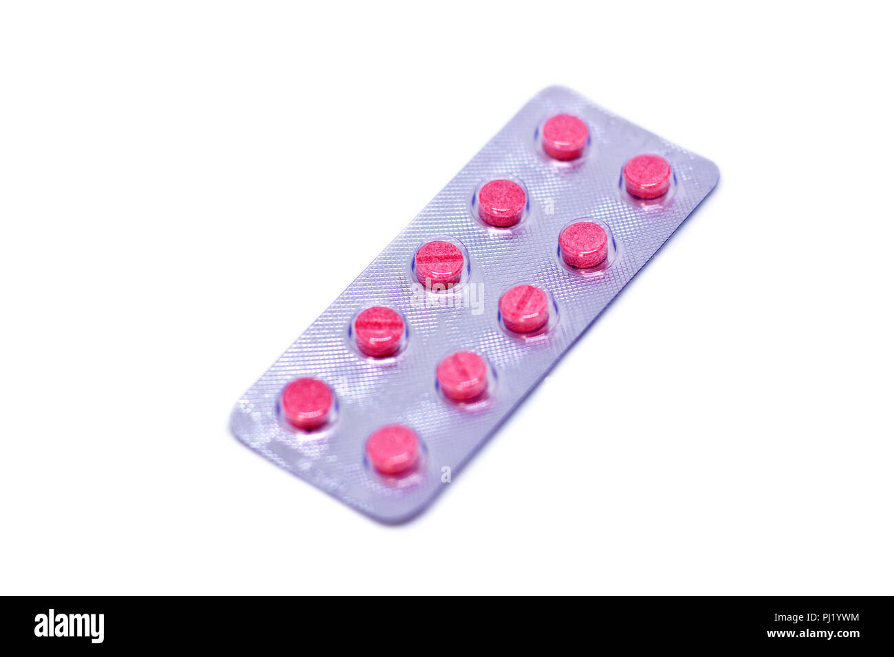Pink pills in a package isolated on a white background Stock Photo - Alamy