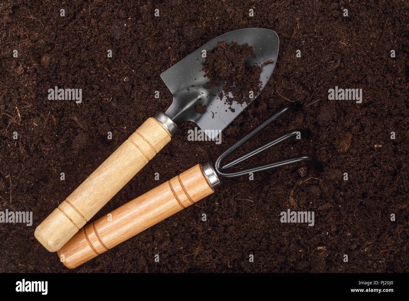 garden tools in soil as a background closeup Stock Photo - Alamy