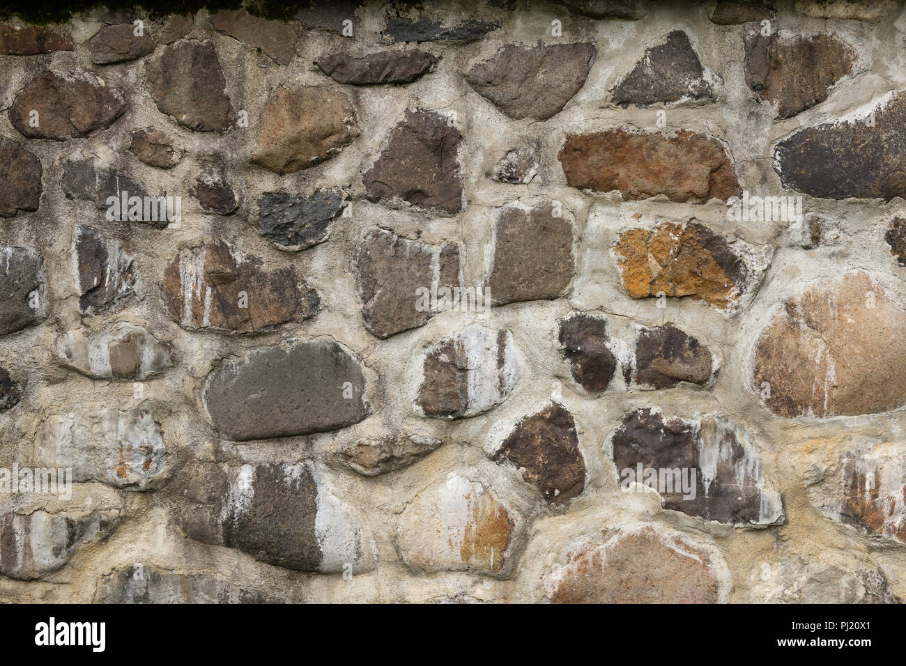 Old stone wall made with irregular blocks background texture with high ...