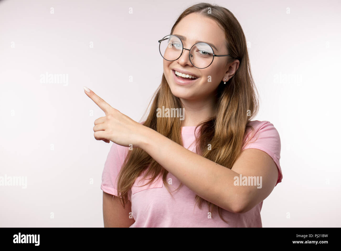 laughing awesome girl showing at copy space Stock Photo - Alamy