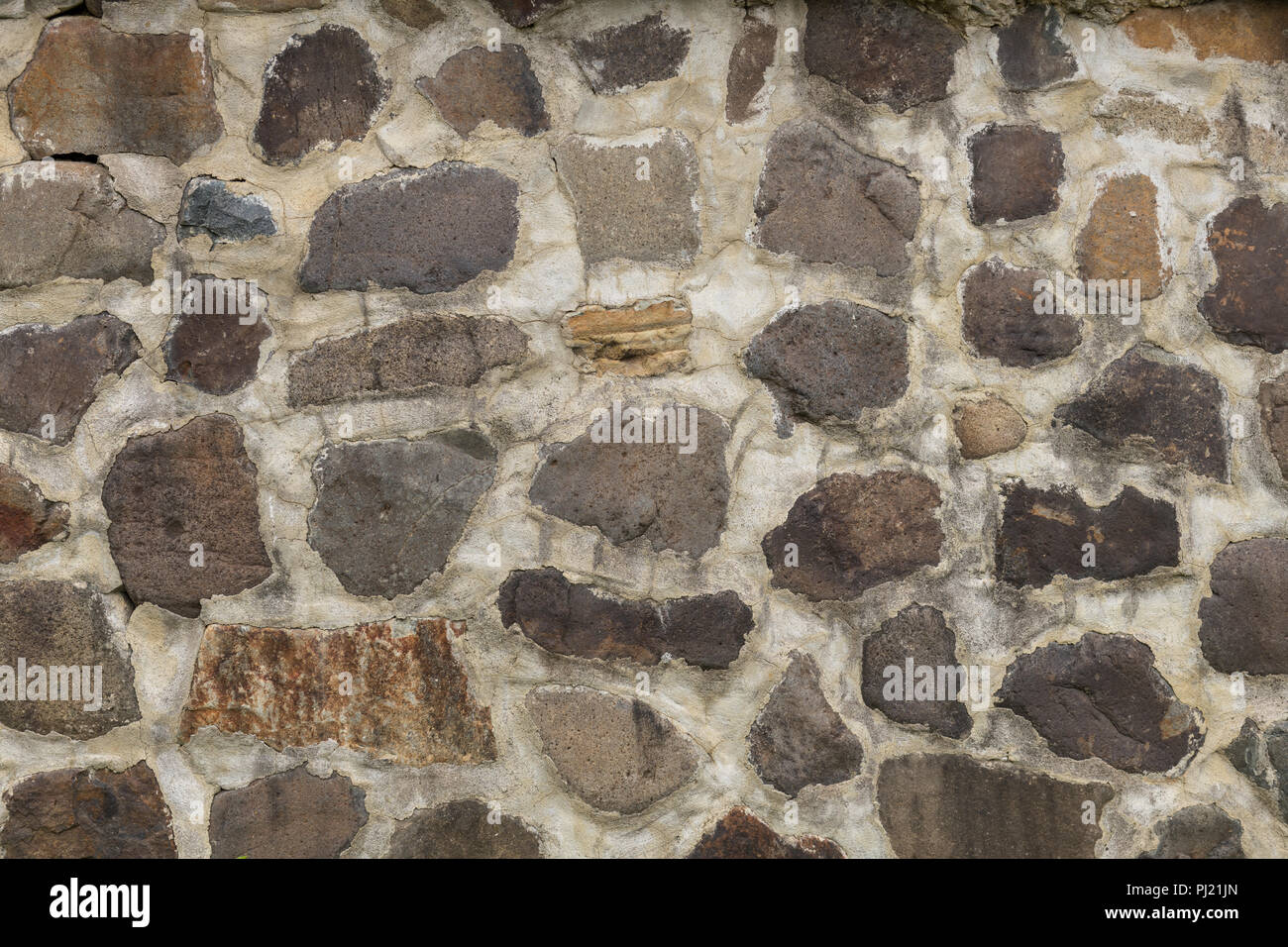 Old stone wall made with irregular blocks background texture with high ...