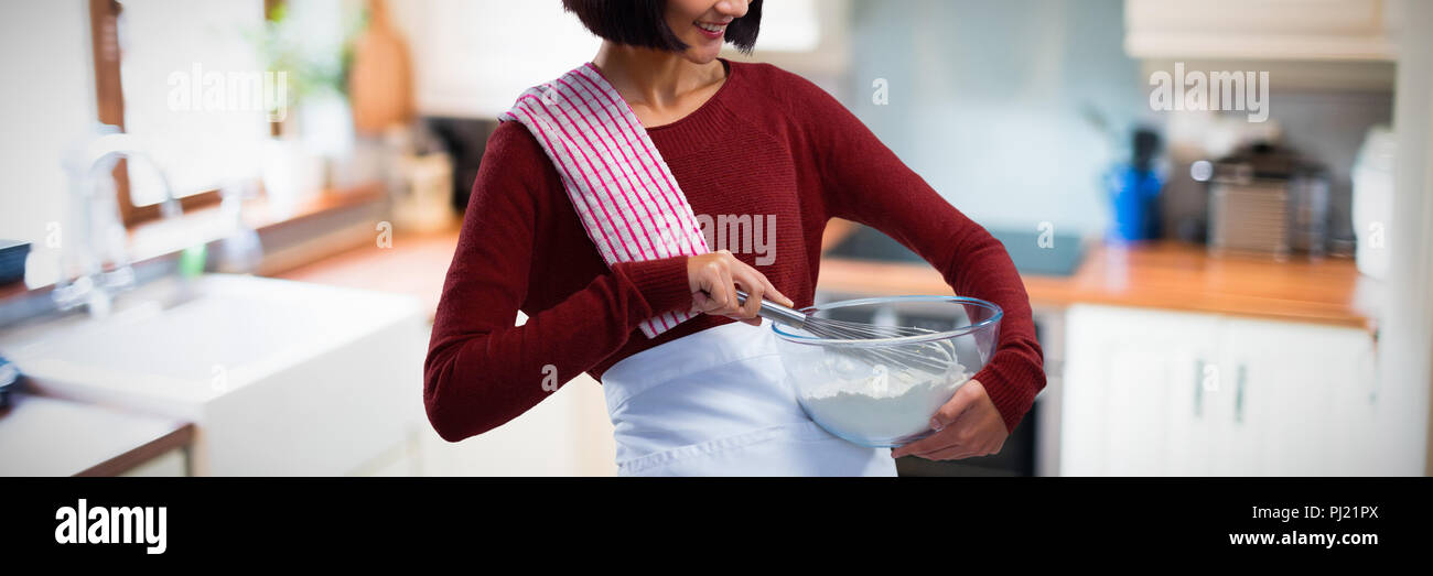 Composite image of female chef mixing flour in bowl with whisk Stock ...