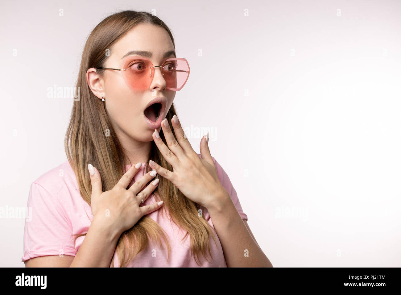 attractive girl with bugged eyes looks surprised Stock Photo - Alamy