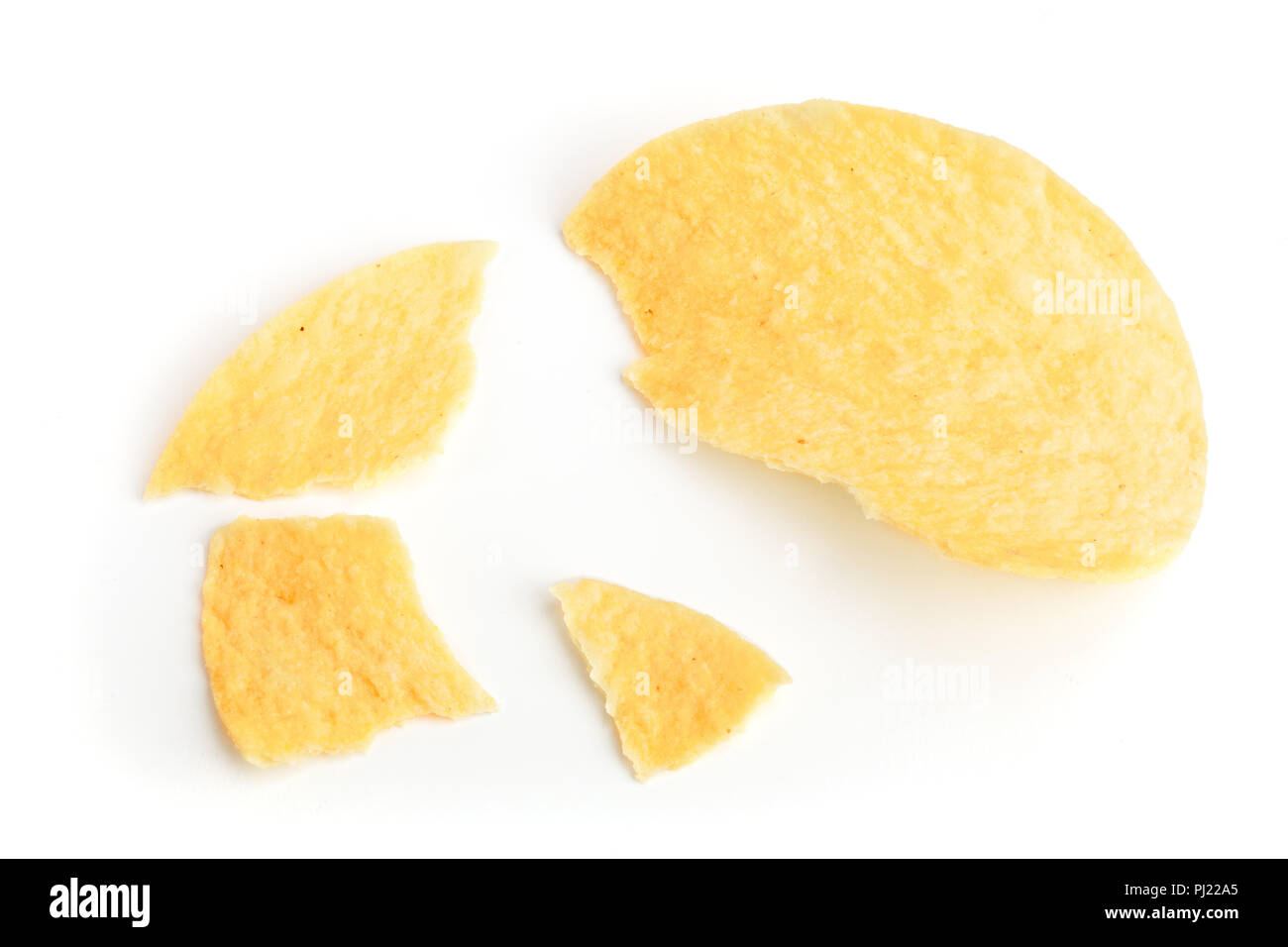 Potato chips crumbs and leftovers isolated over the white background ...