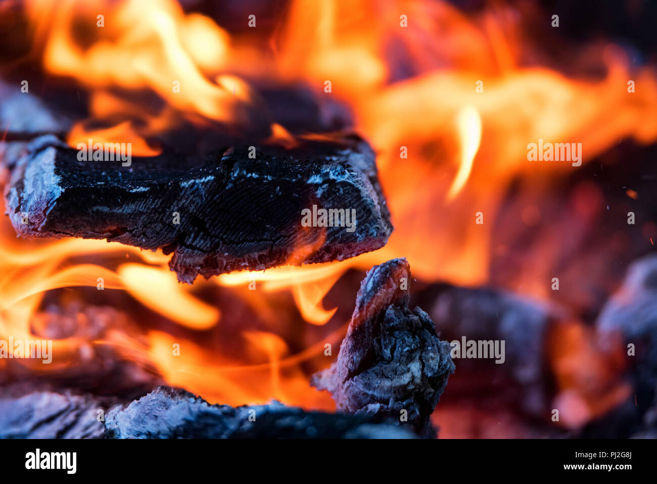 Wooden planks on fire close up background Stock Photo - Alamy
