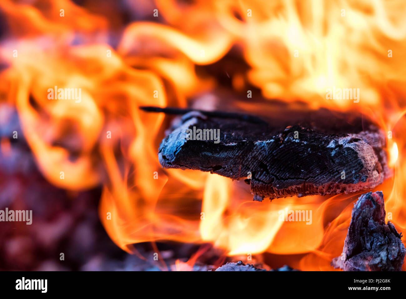 Wooden planks on fire close up background Stock Photo - Alamy