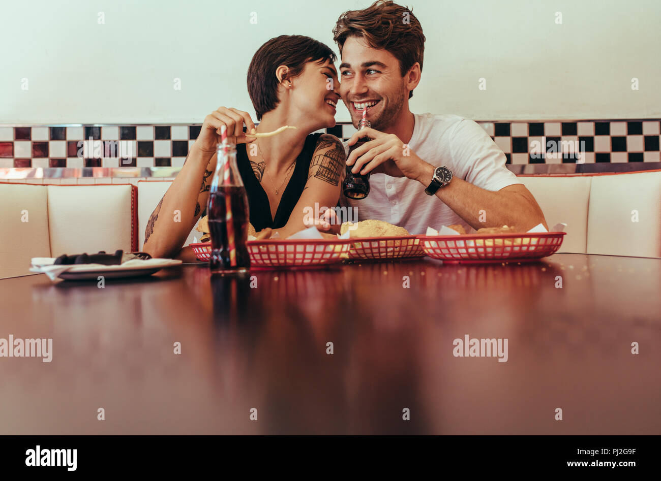 Young woman eating boyfriend in diner hi-res stock photography and ...