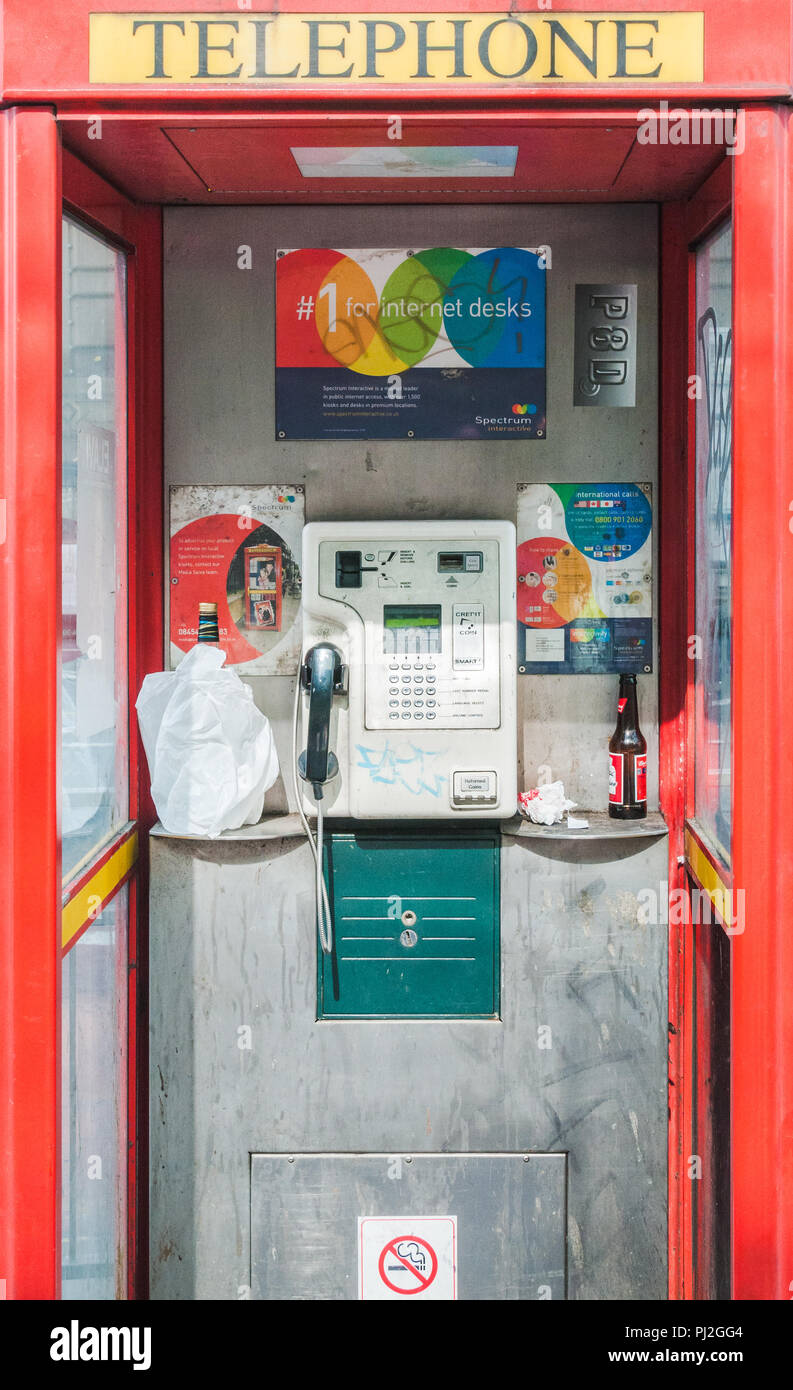 Derelict red telephone box in Manchester with graffiti and empty ...