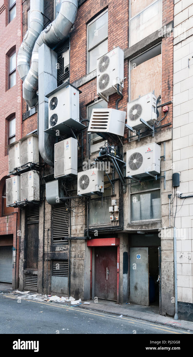 Dirty looking back street in Manchester with lots of air conditioning ...