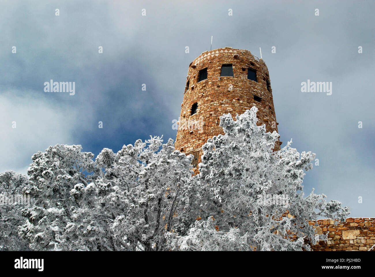 Winter scene with snow-covered trees and Desert View Watchtower on the ...