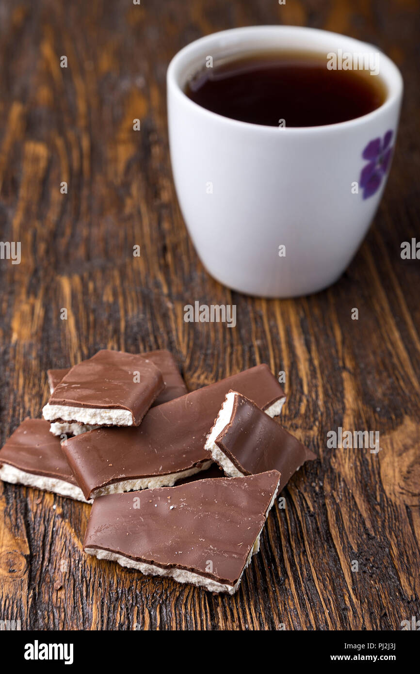 Chopped chocolate and tea on the wooden desk Stock Photo - Alamy