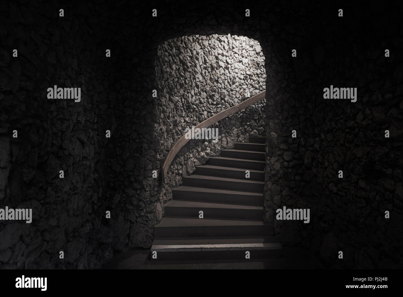 Old dark cellar made from small pieces of stone and staircase towards ...