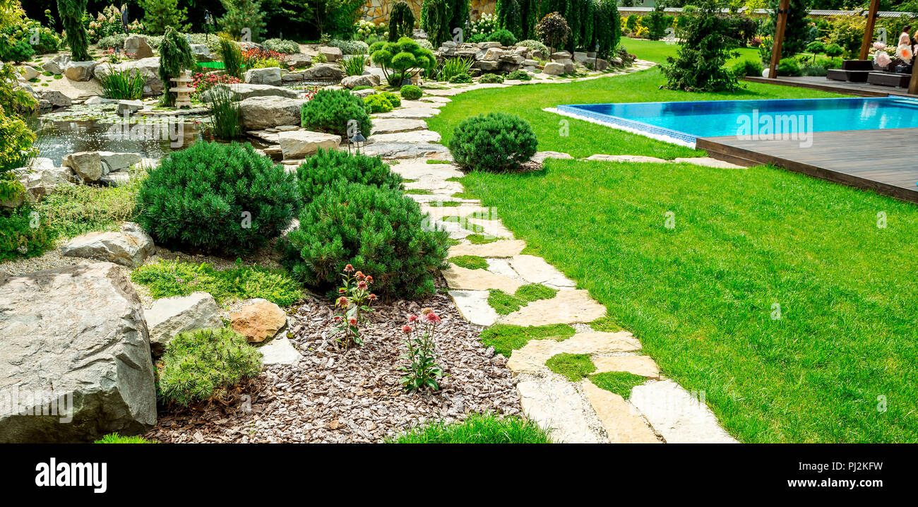 A country house with a beautiful backyard behind the house, landscape ...