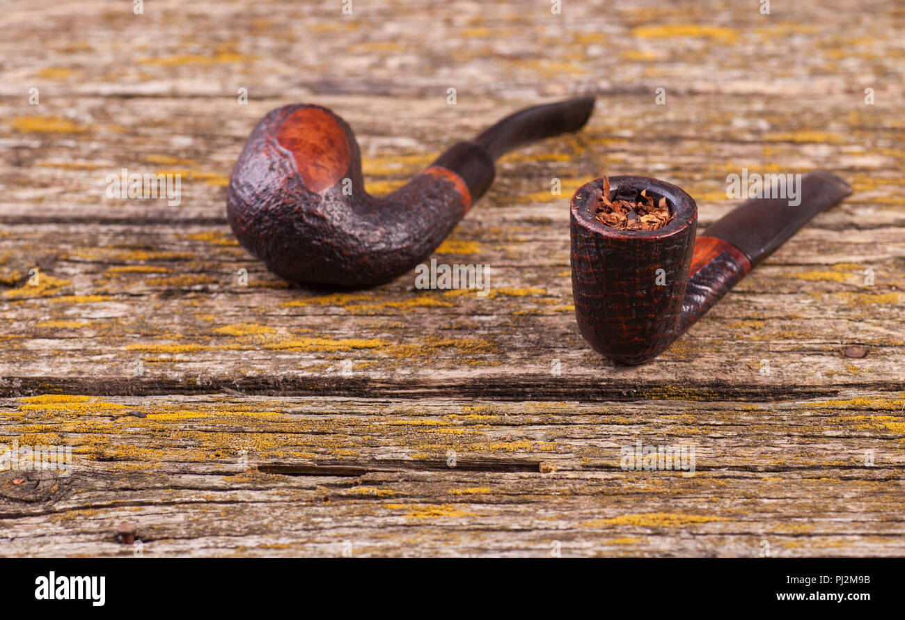 Vintage smoking pipes. Good expensive tobacco. Background of old boards ...