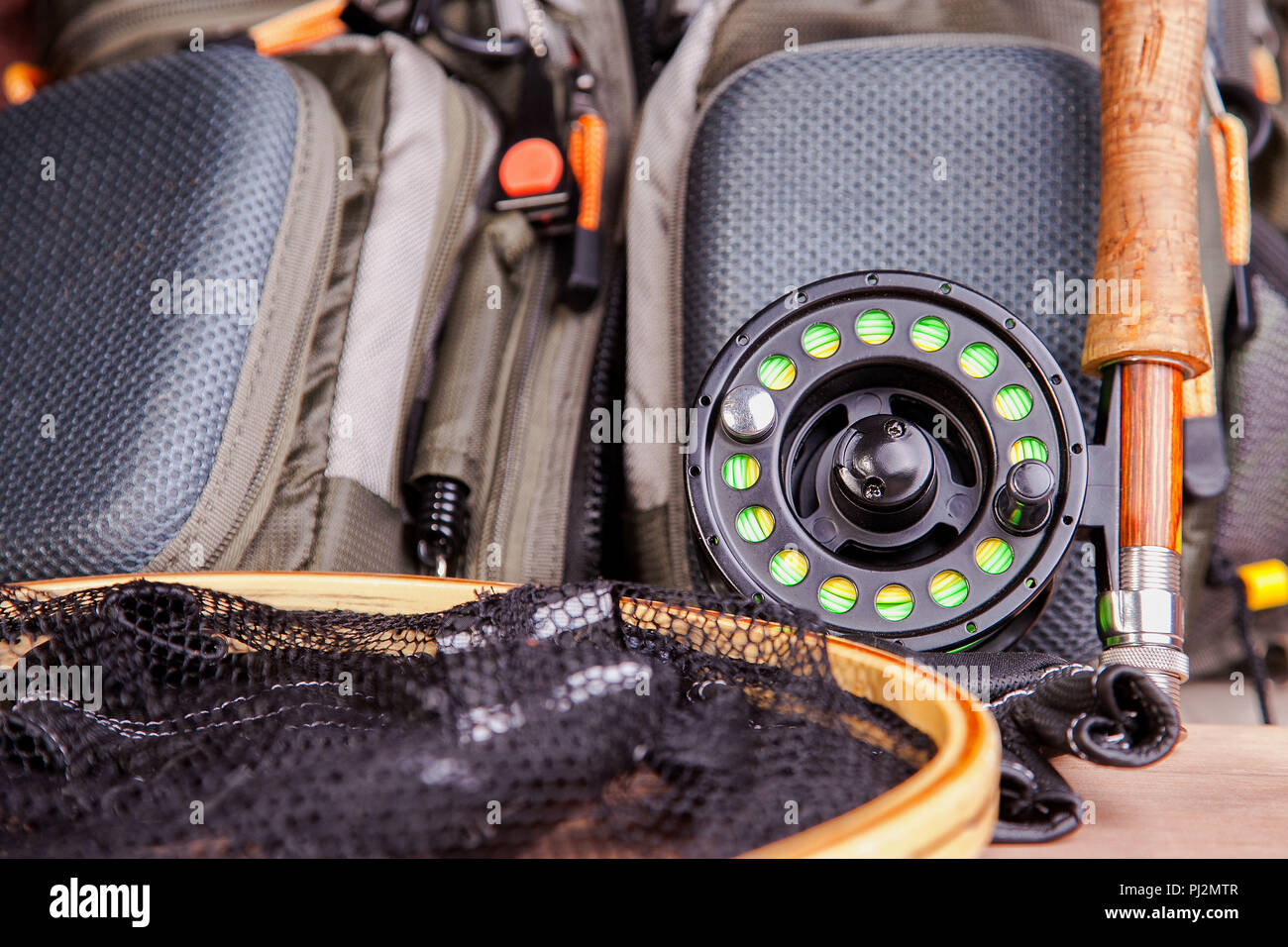 fly fishing rod with a coil and flies lie on old, wooden boards Stock ...