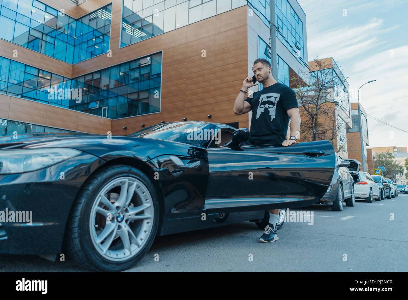 Young businessman getting out car hi-res stock photography and images ...