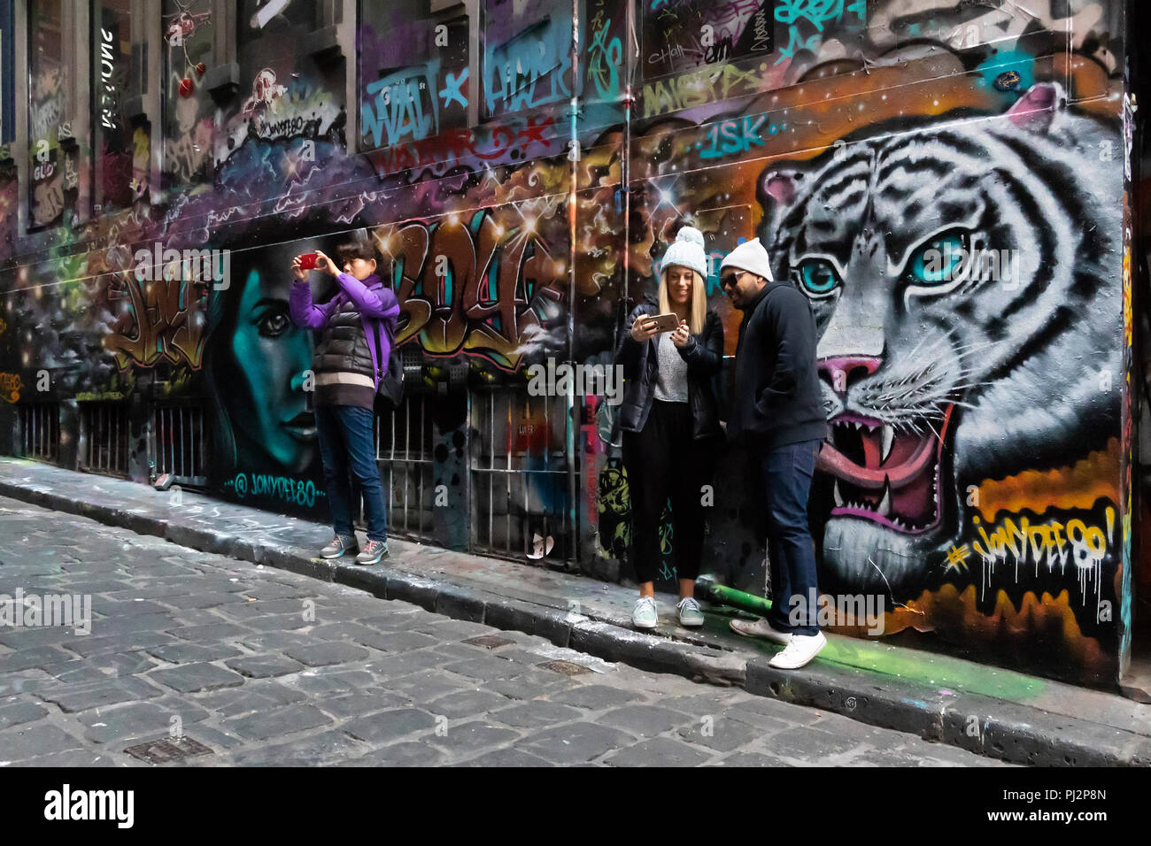 Tourists admiring street art in Hosier Lane; one of Melbourne's most ...